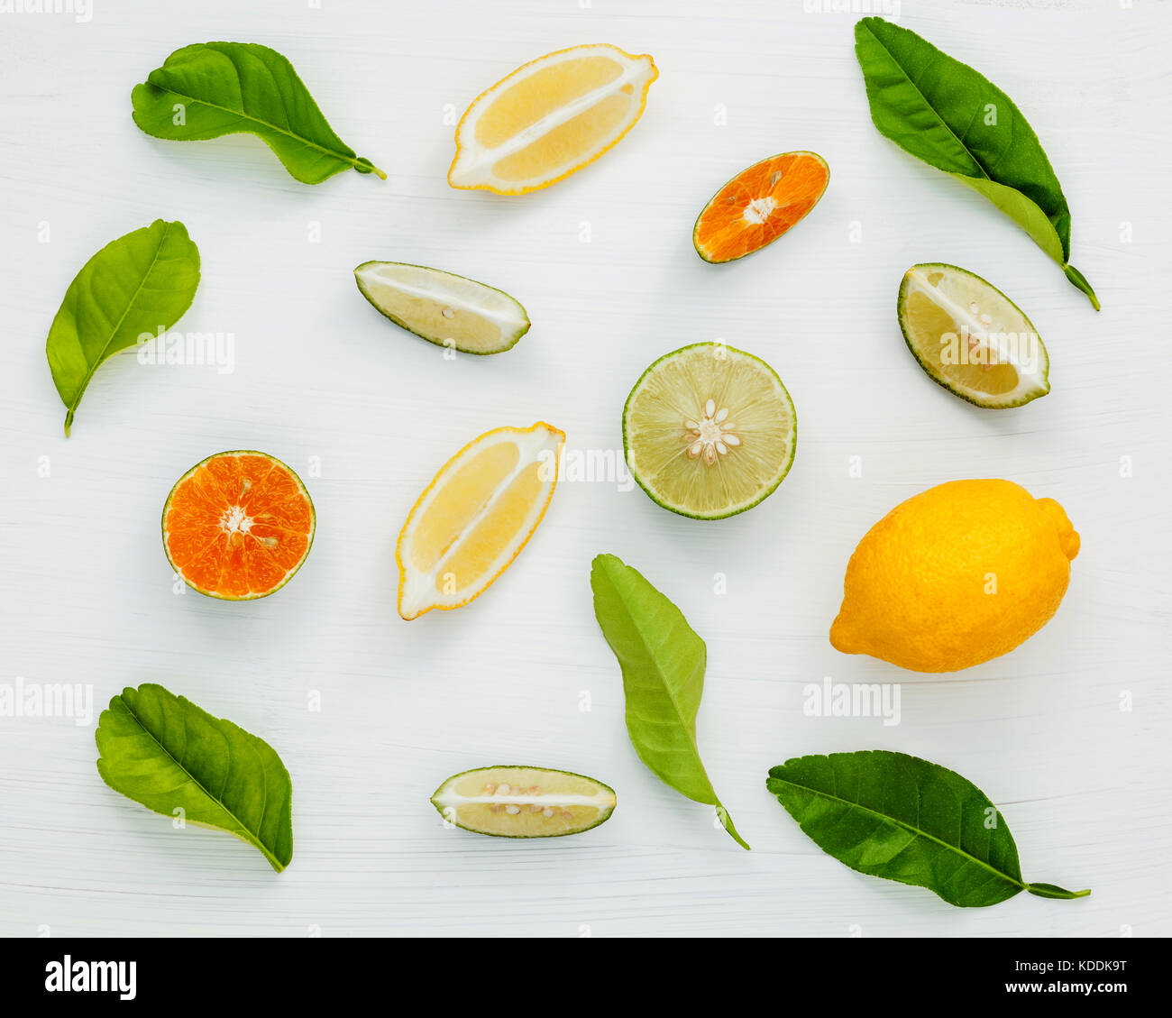 Mixed fresh citrus fruits and leaves background. Fresh lemons, lemon ...