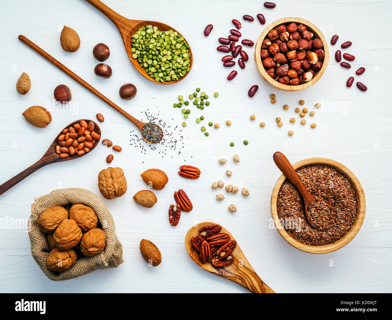 Bowls and spoons of various legumes and different kinds of nuts walnuts ...