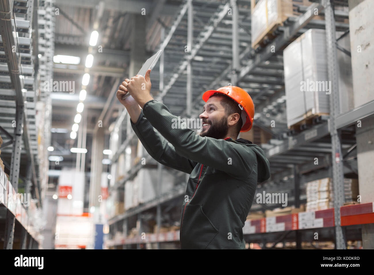 Warehouse manager checking his inventory in a large warehouse Stock ...