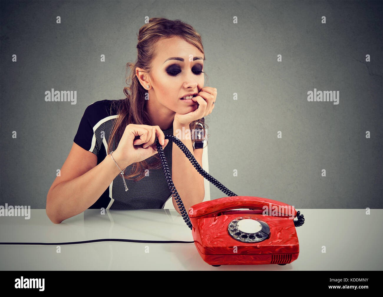 Young beautiful woman waiting for a call Stock Photo - Alamy