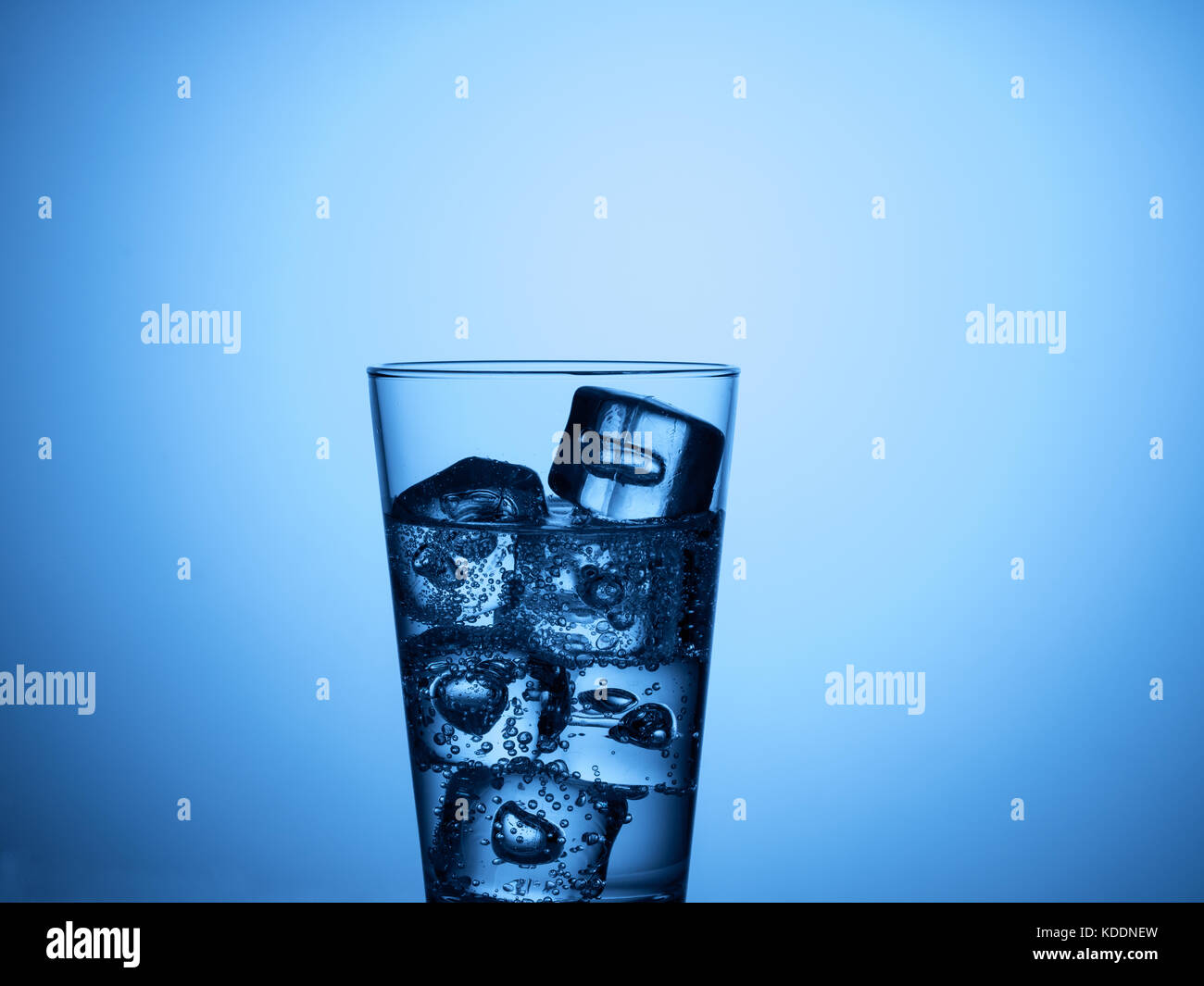 isolated glass of water with ice cubes on a light blue background Stock ...