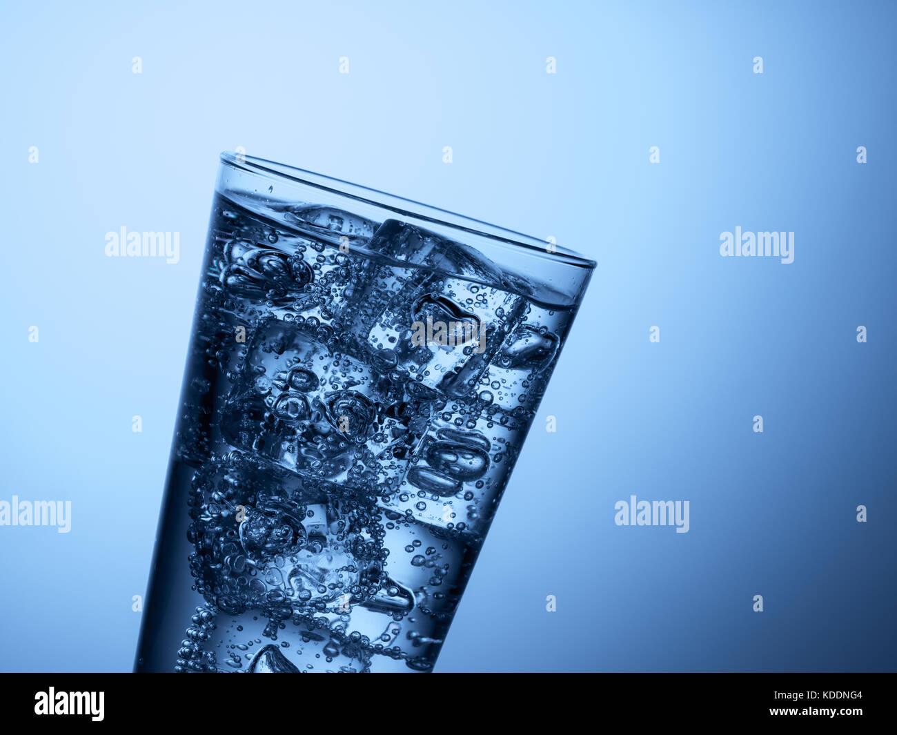 isolated glass of water with ice cubes on a light blue background Stock ...