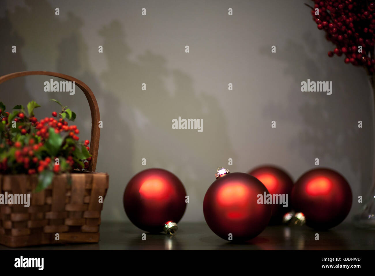 matt and shiny Christmas tree toy of red color near the wicker baskets ...