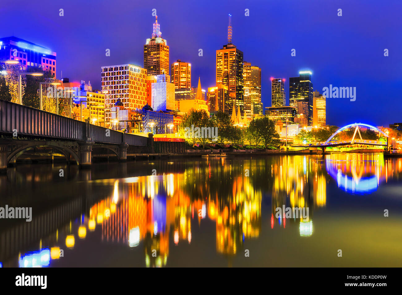 Bright illuminated city of Melbourne reflecting lights in still waters ...