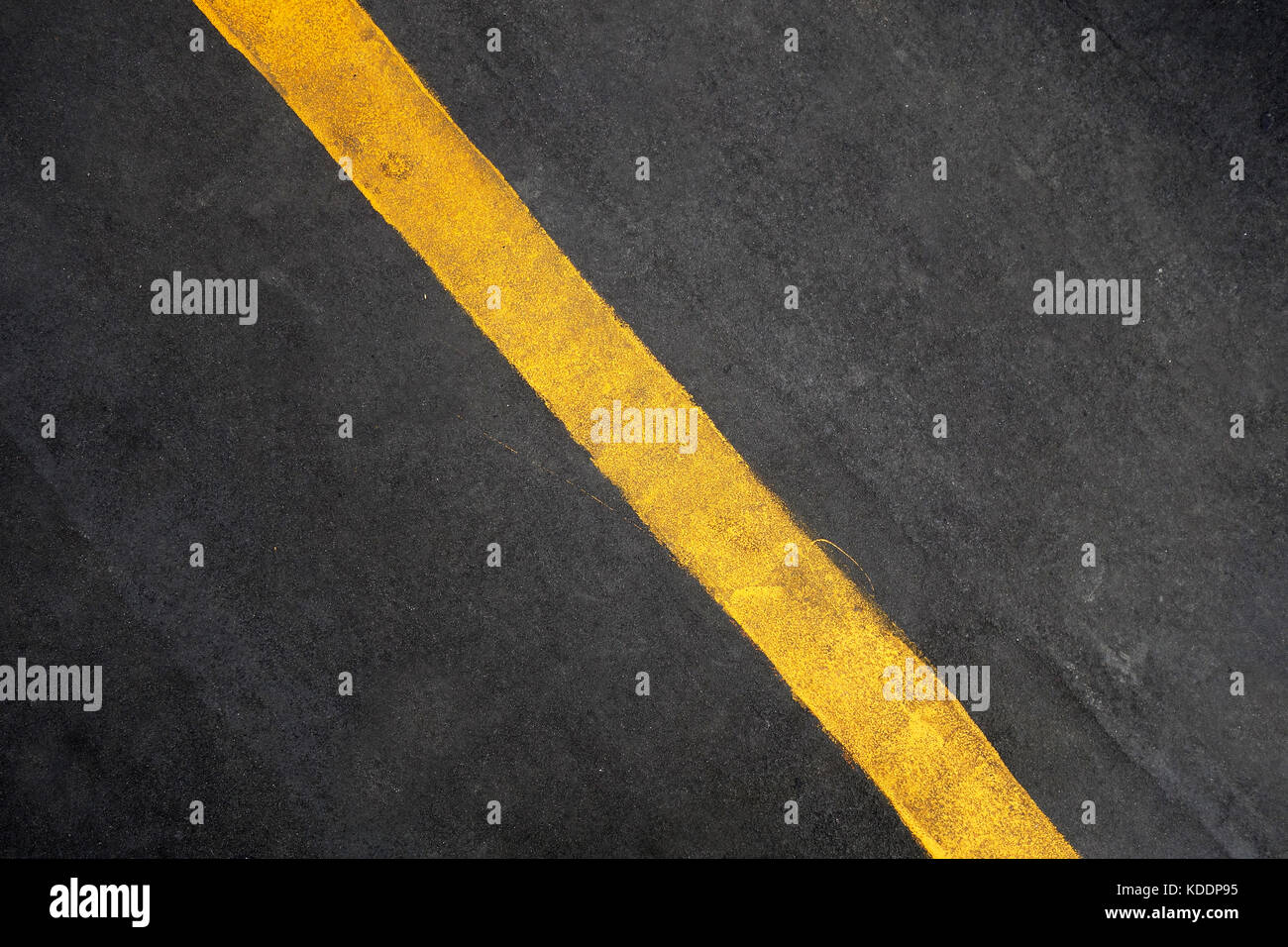 Single yellow line on road texture background Stock Photo - Alamy
