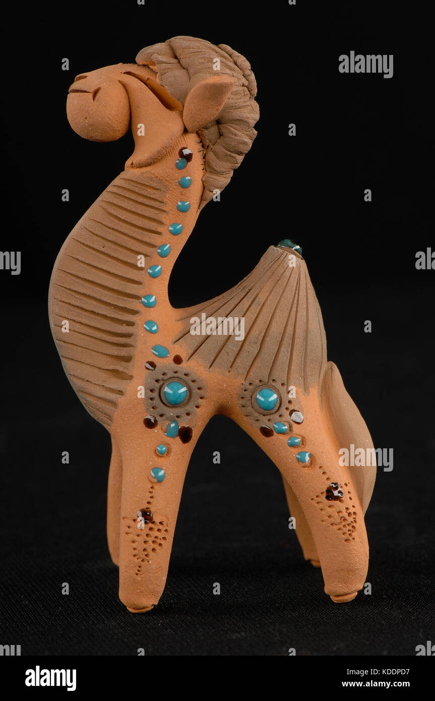 Asian and Oriental painted toy from burnt clay in the form of a camel ...