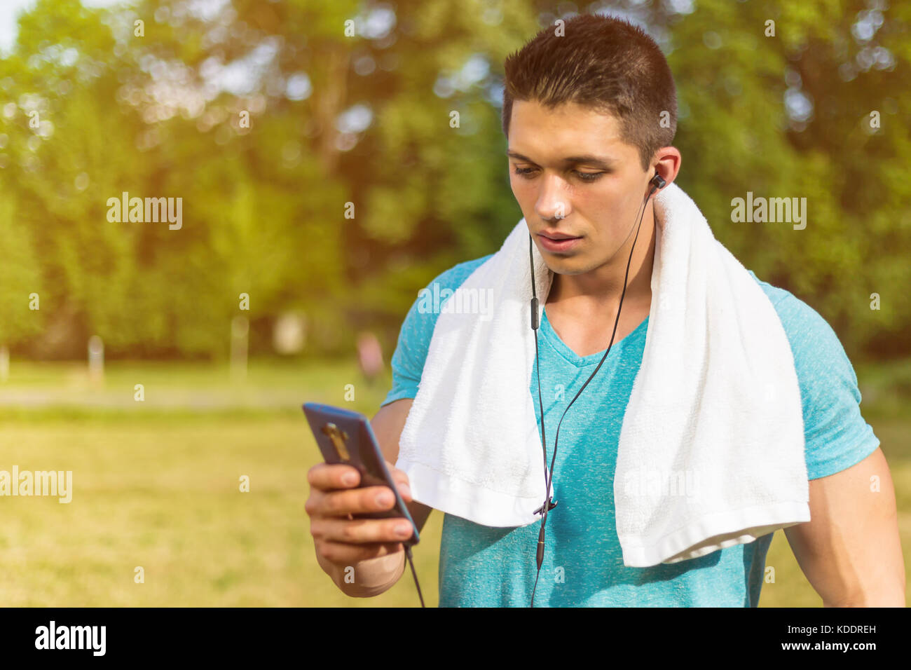 Young man running sports smartphone app fitness training outdoor ...