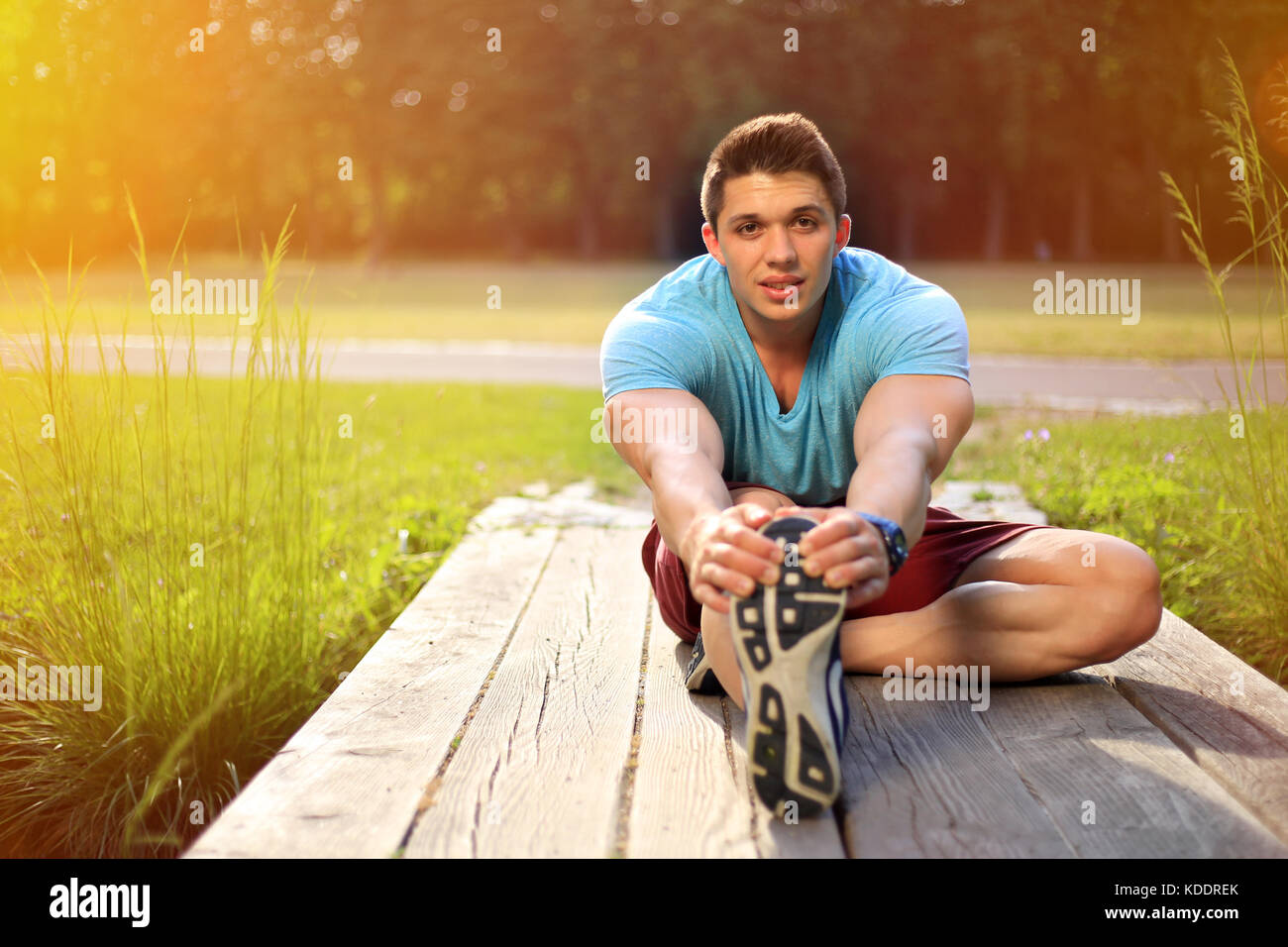 Jogger making warm up exercises hi-res stock photography and images - Alamy