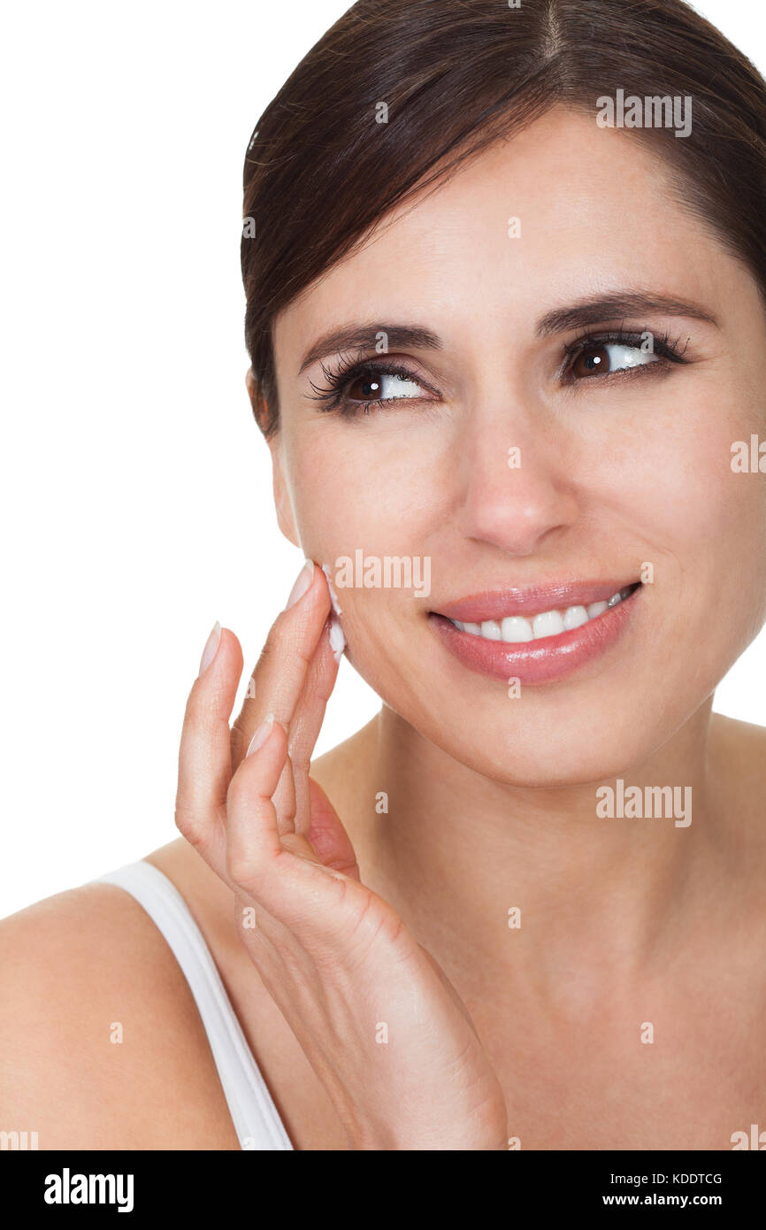 Woman putting lotion on face hi-res stock photography and images - Alamy