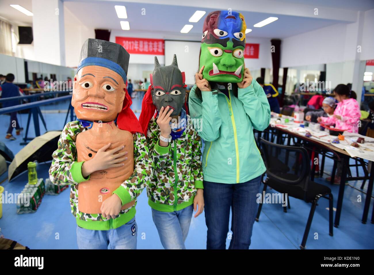 Enshi, China. 13th October, 2017. Students learn to make masks of Nuo ...