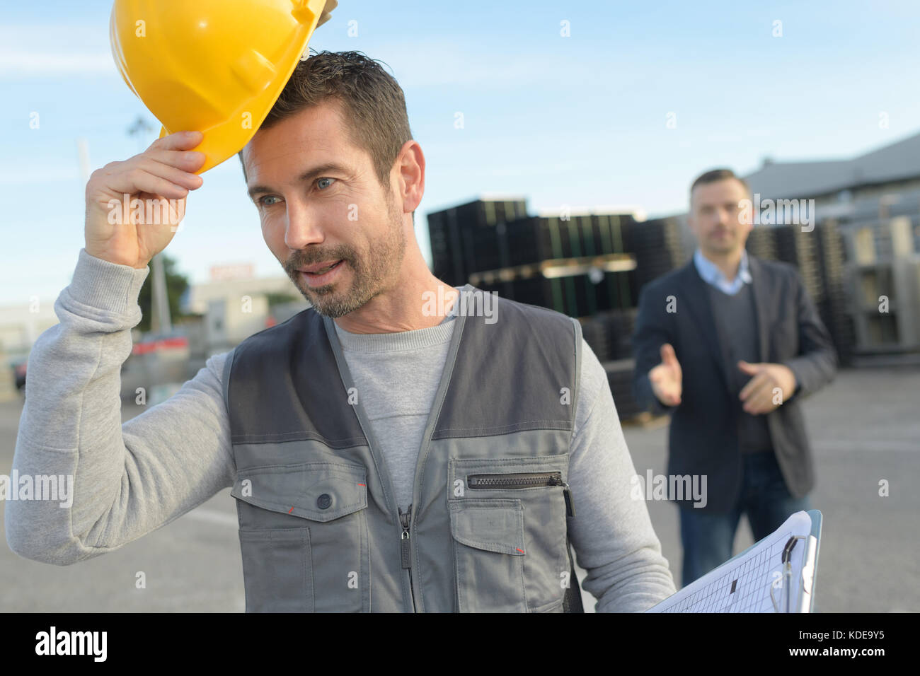 stressed engineer and upset builder walking away Stock Photo - Alamy