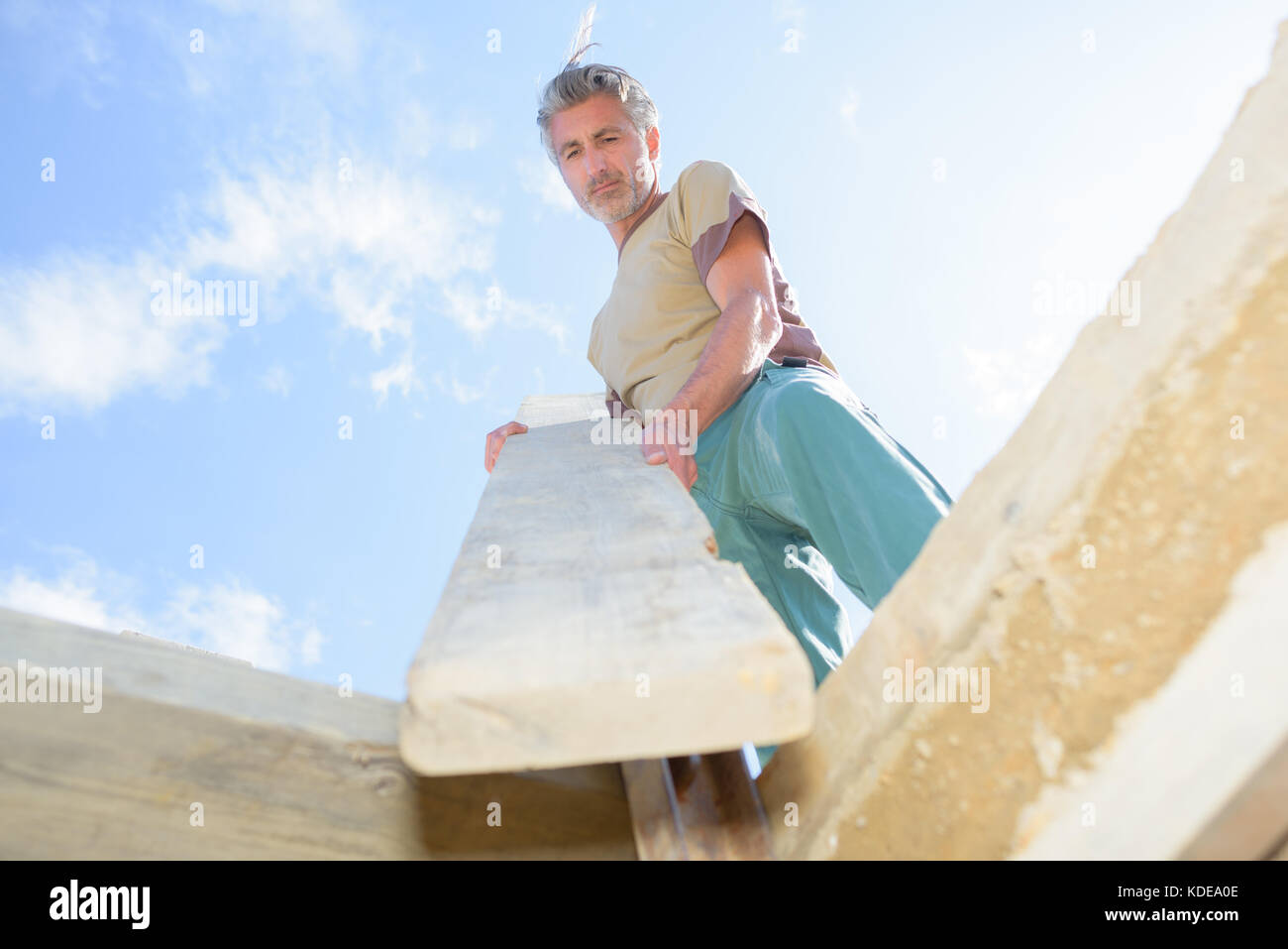 carpenter or homeowner fitting a section of wood Stock Photo - Alamy