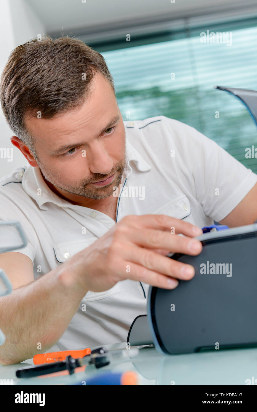 Man fixing a printer Stock Photo - Alamy