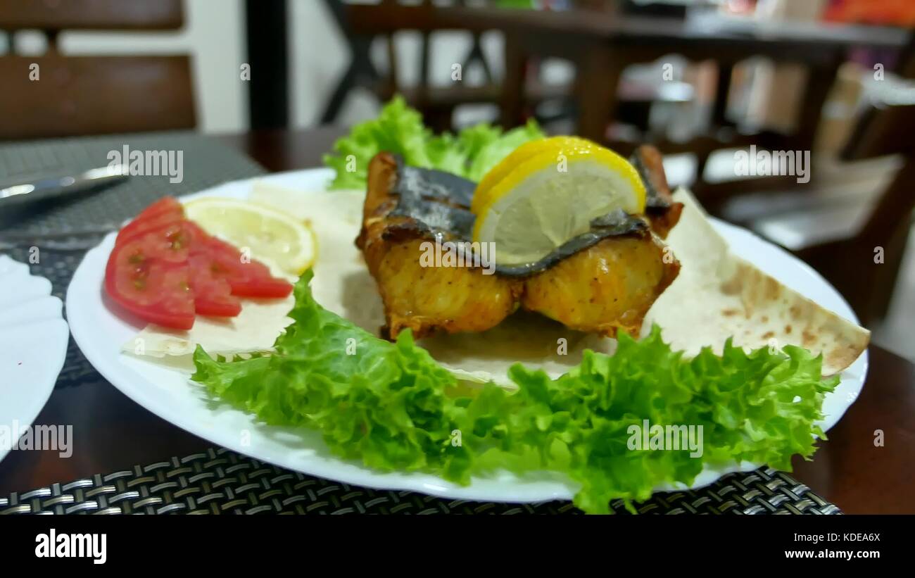 Dish of fish. Fried shark eating on a plate with lemon. Lunch at the ...
