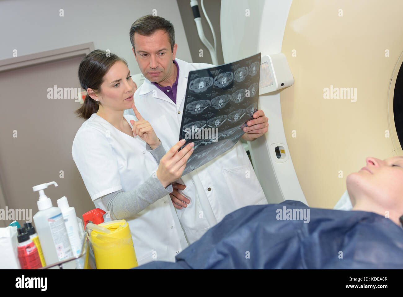 doctors checking x-ray next to patients undergoing mri scan Stock Photo ...