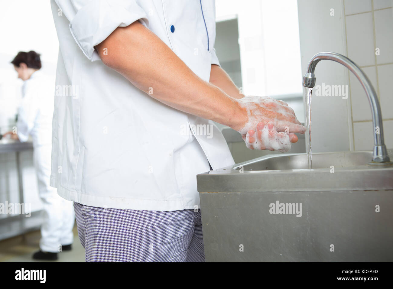 chefs washing hands in an industrial kitchen Stock Photo - Alamy