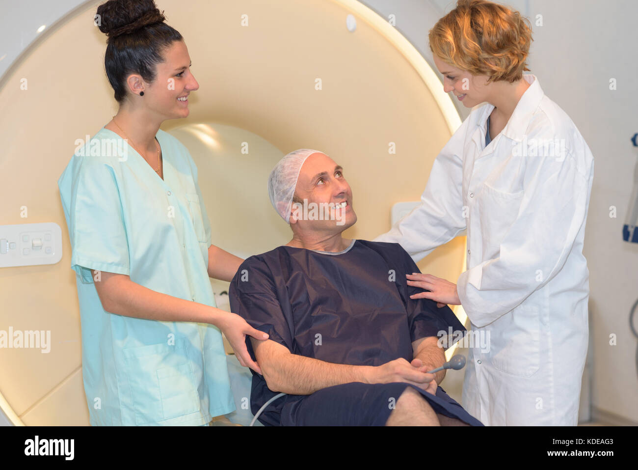 Nurses reassuring patient at mri scanner Stock Photo - Alamy