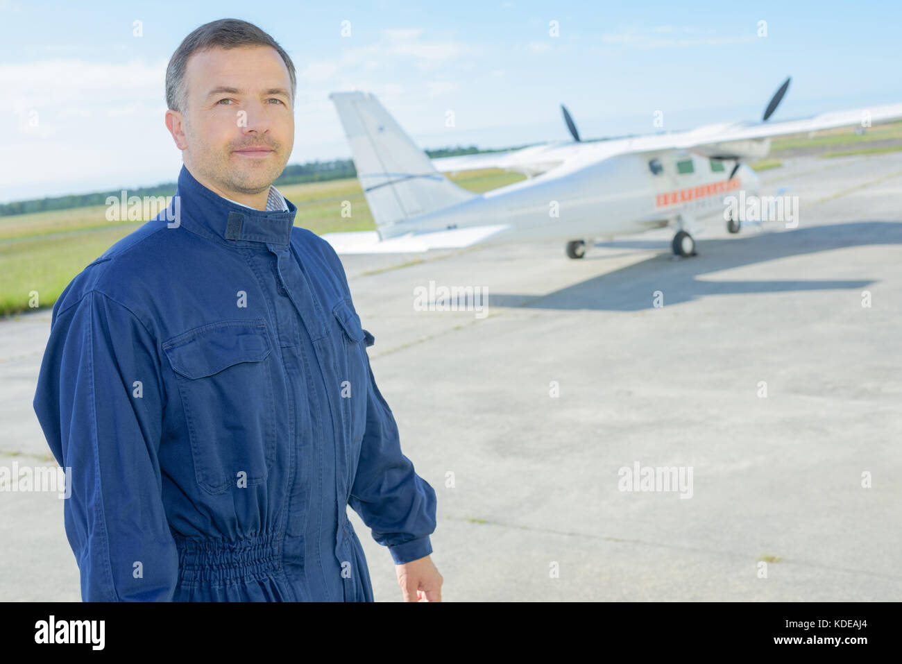 Man and aircraft on runway Stock Photo - Alamy