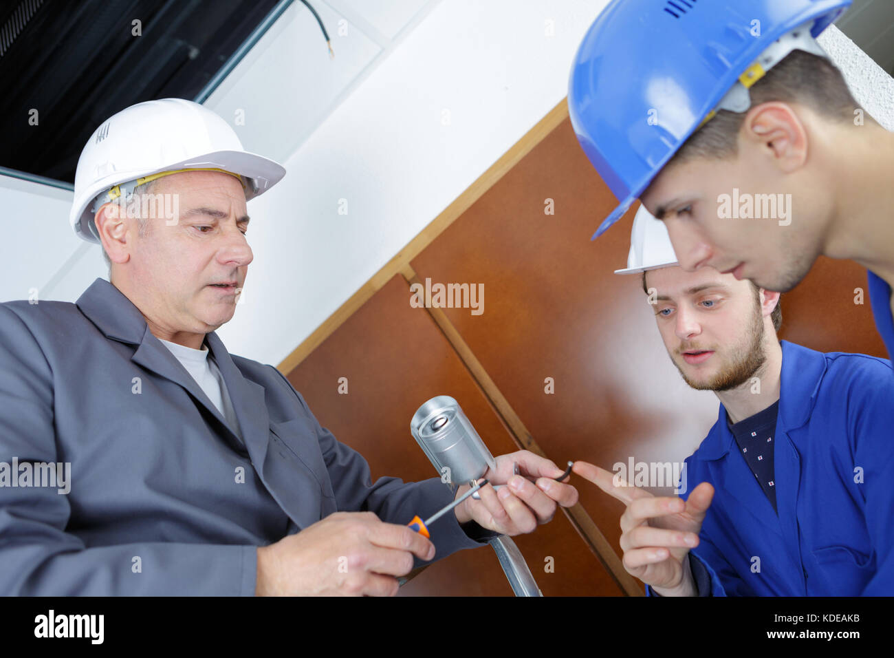 technician talking to cctv apprentices Stock Photo - Alamy
