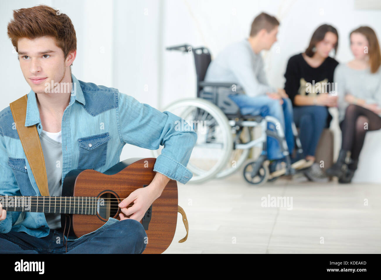 handicapped devoted musician playing guitar Stock Photo - Alamy