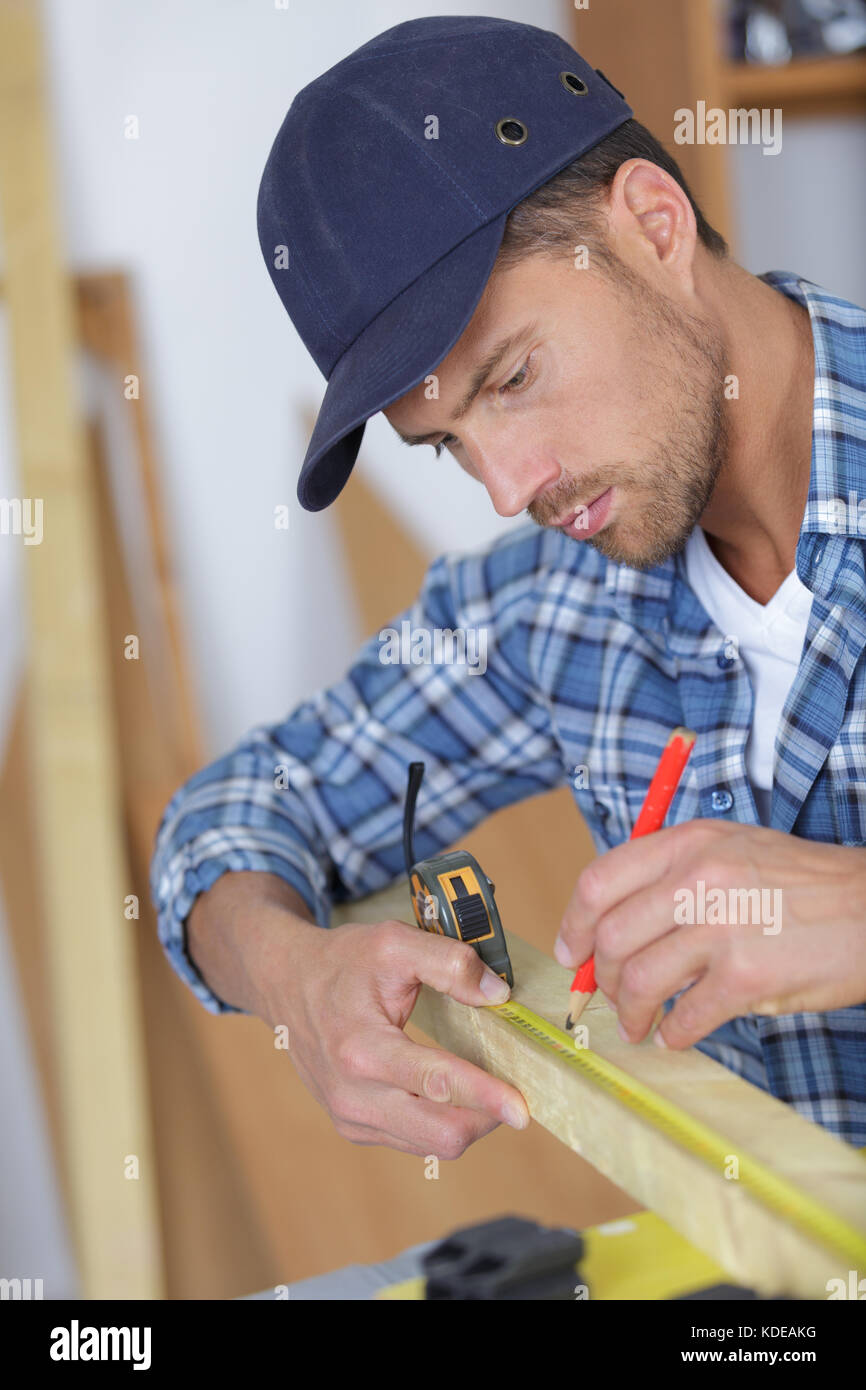 carpenter measuring wood Stock Photo - Alamy