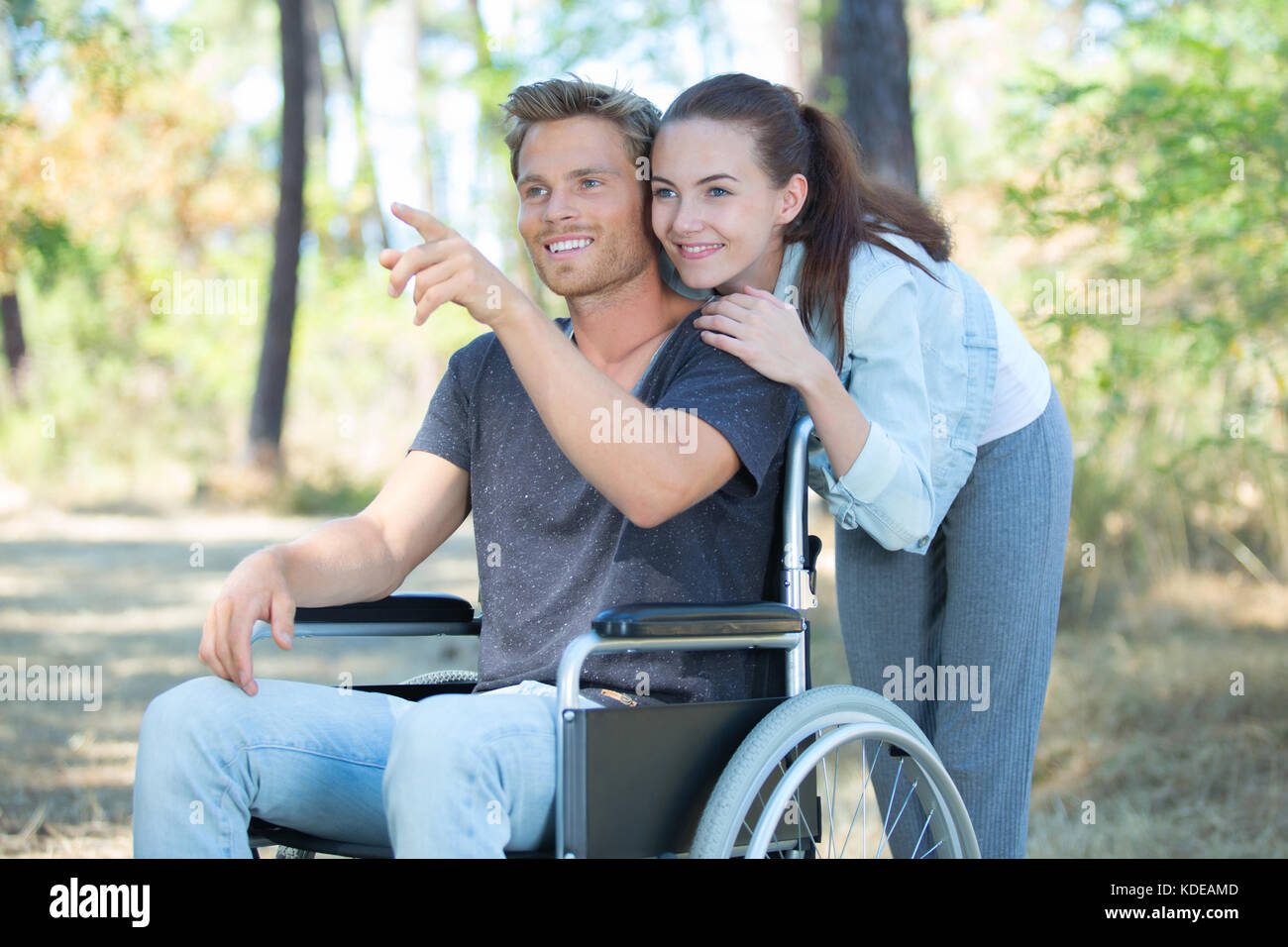loving couple in wheelchair walking outdoors Stock Photo - Alamy
