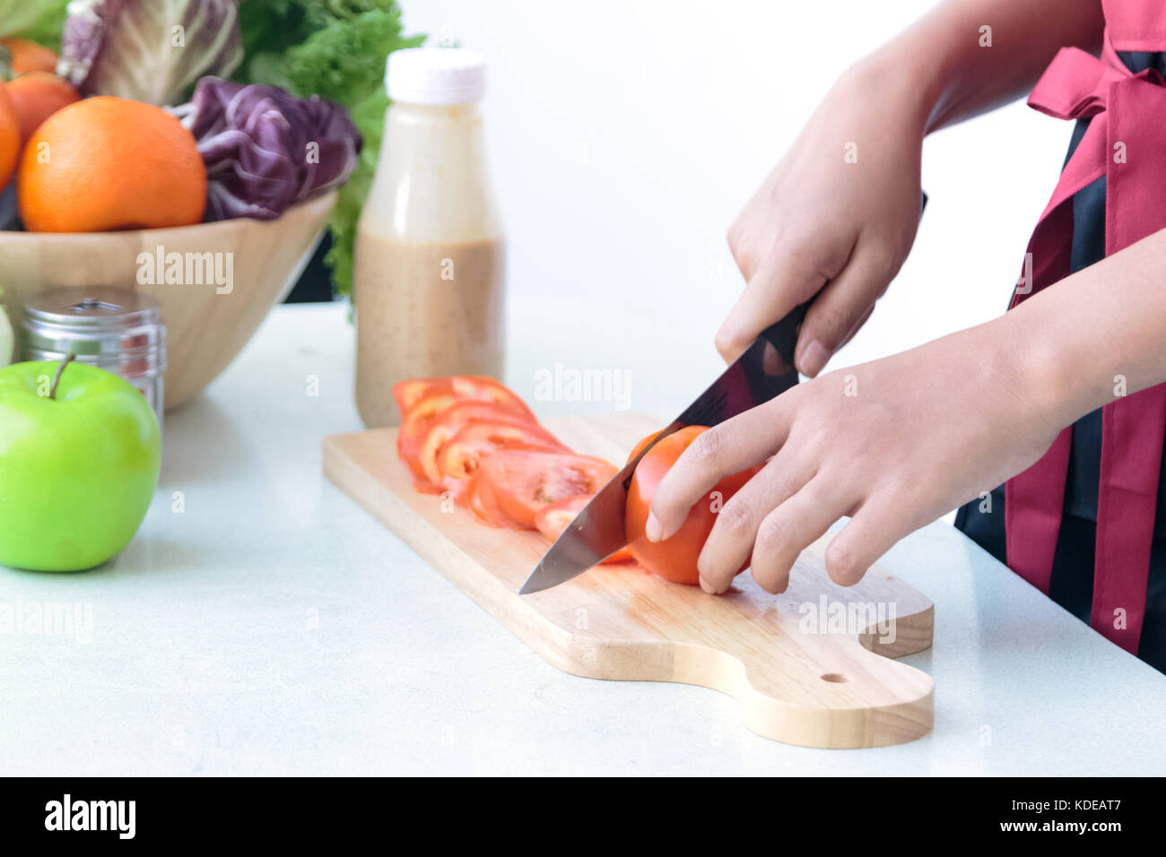 Close up of woman's chef hands cooking vegetables salad in the kitchen ...