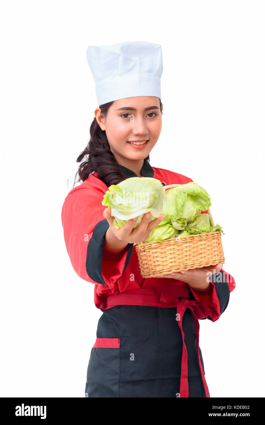 Smiling chef woman in red uniform holding vegetable basket Stock Photo ...