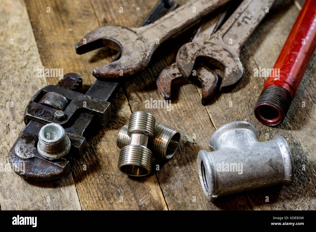 Hydraulics, tools for plumber on wooden table. Workshop, table and ...