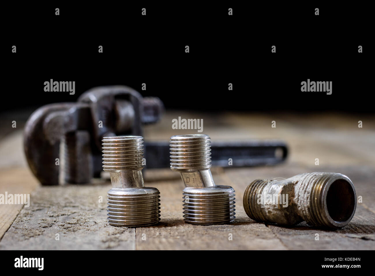 Hydraulics, tools for plumber on wooden table. Workshop, table and ...