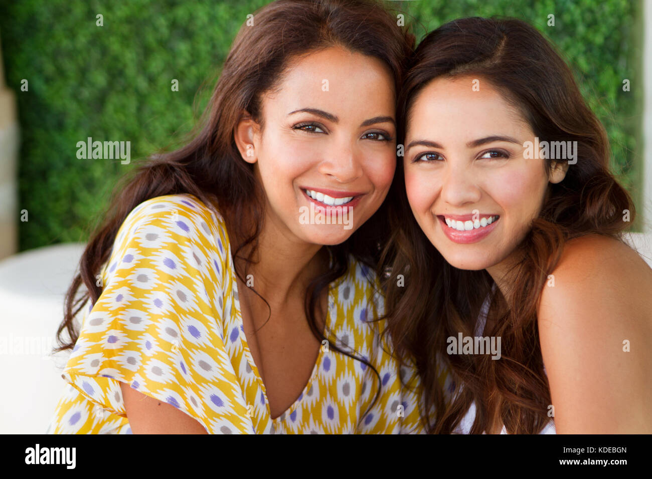 Beautiful Hispanic women smiling outside Stock Photo - Alamy