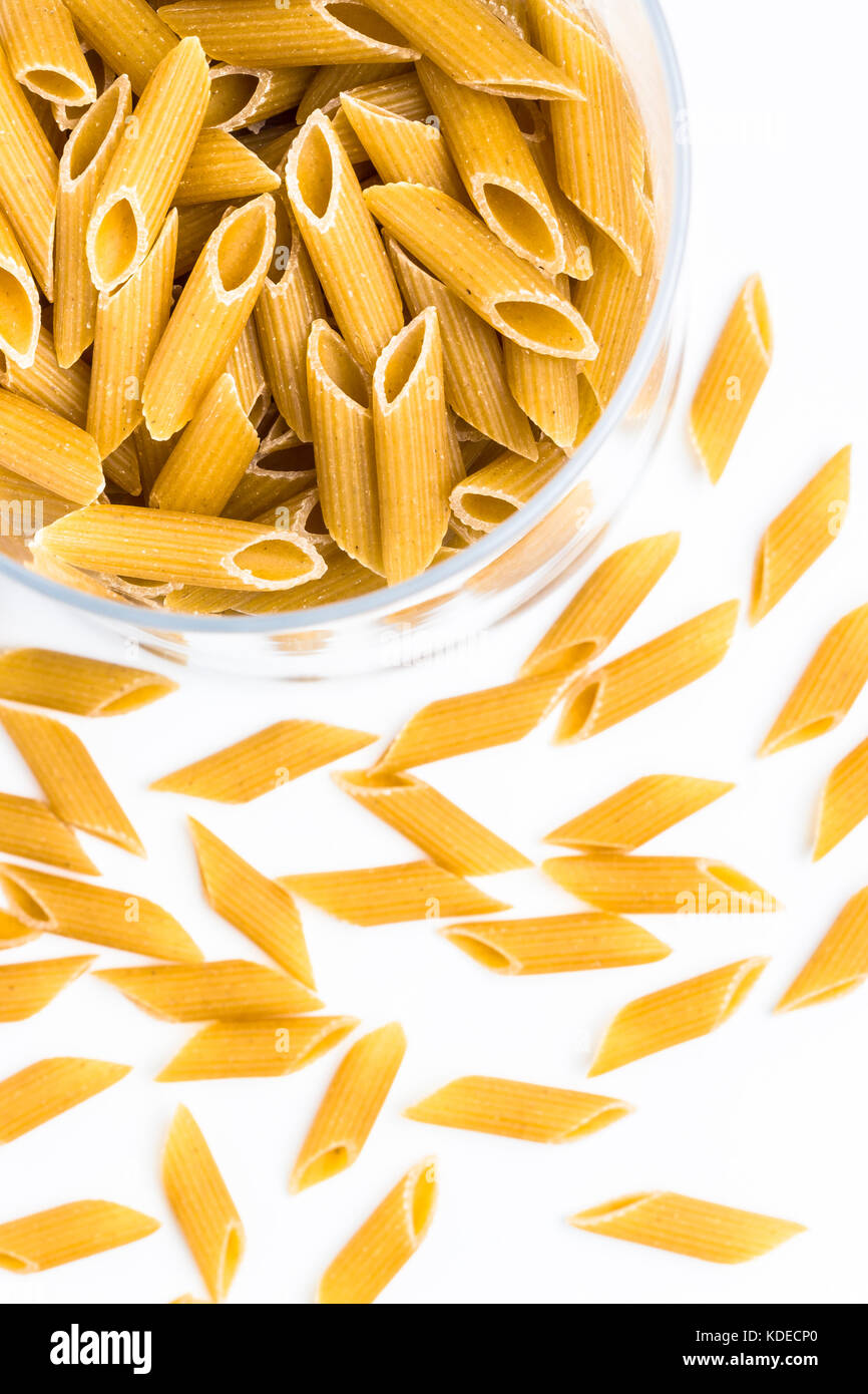 Italian dry pasta in the shape of pens in a glass bowl Stock Photo - Alamy