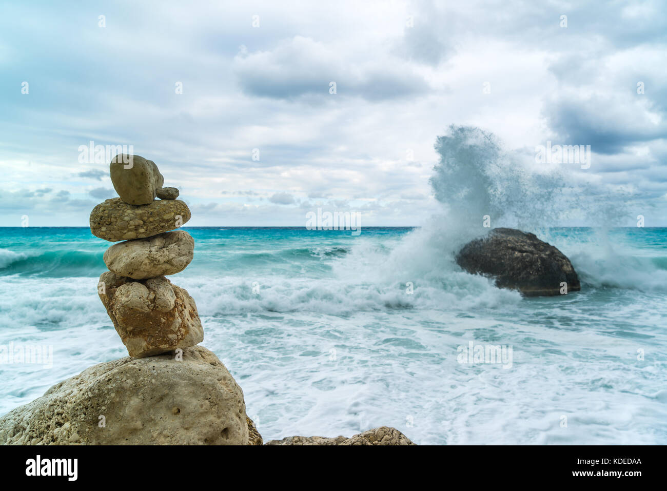 A balanced pile of stones in front of the waves from the ocean Stock ...