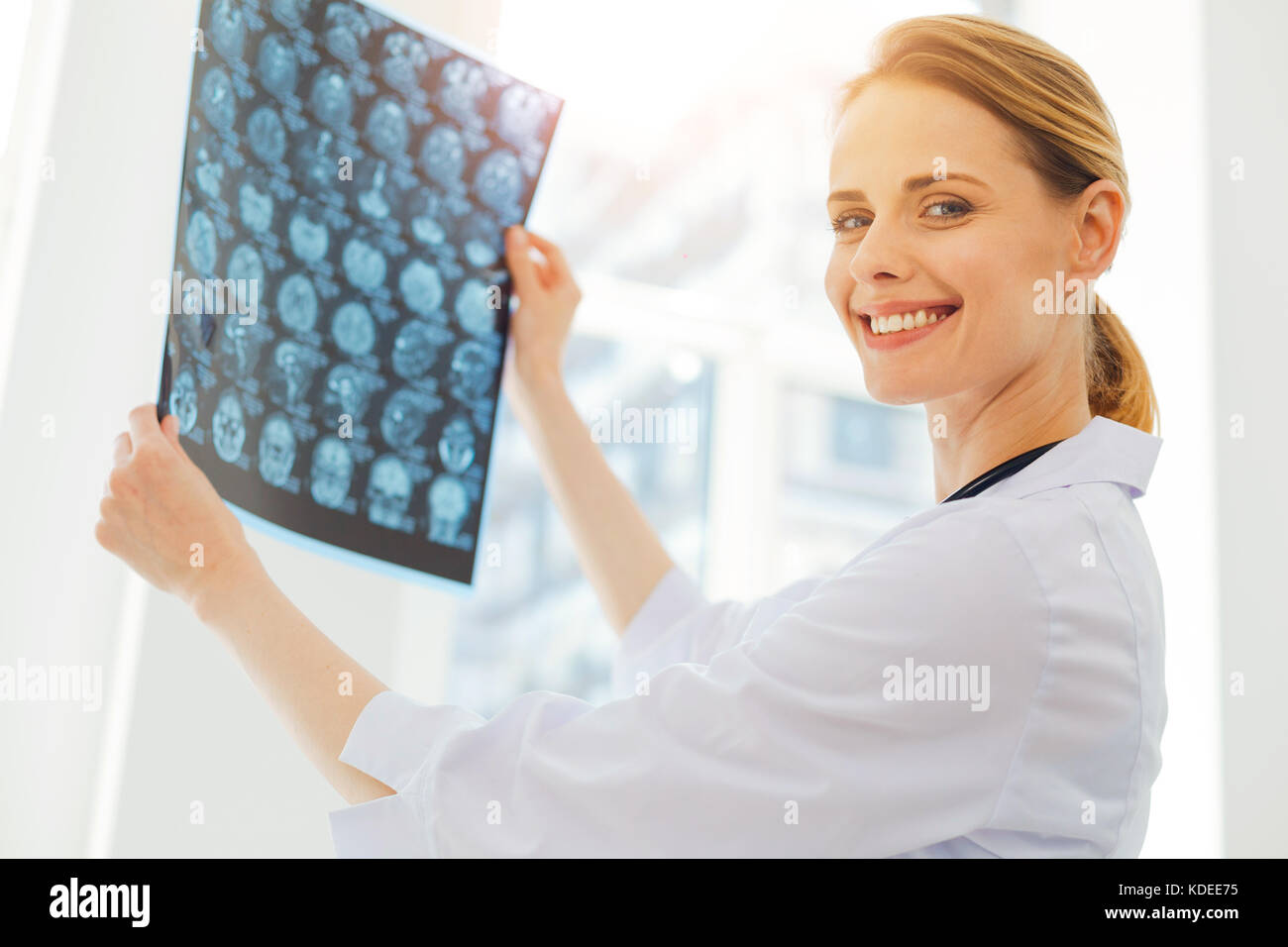 Cheerful medical professional posing with x ray scan picture Stock ...