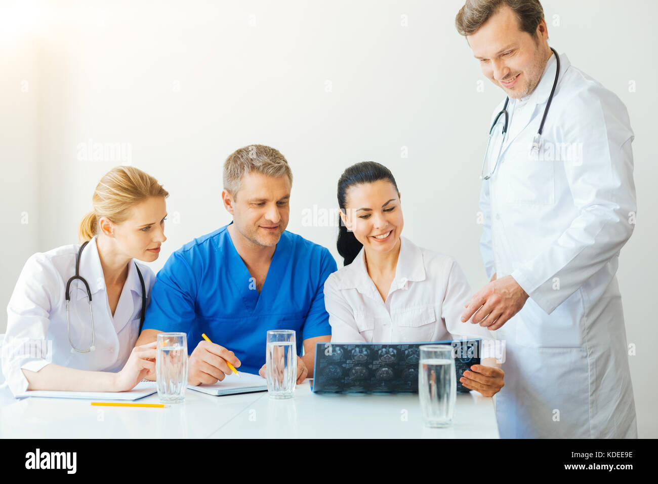 Friendly medical coworkers chatting over illness of patient Stock Photo ...
