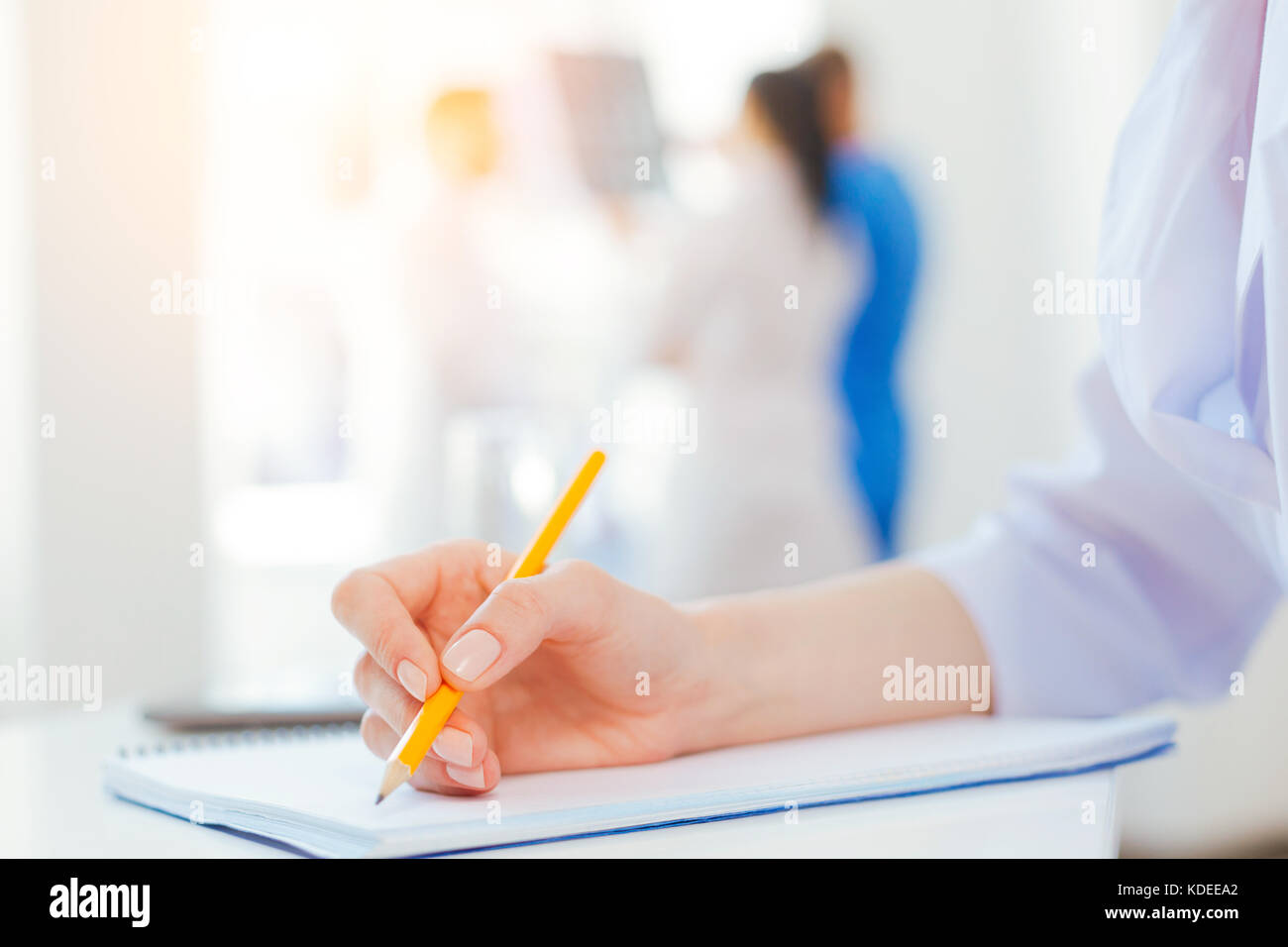 Scaled up look on young woman writing in hospital Stock Photo - Alamy