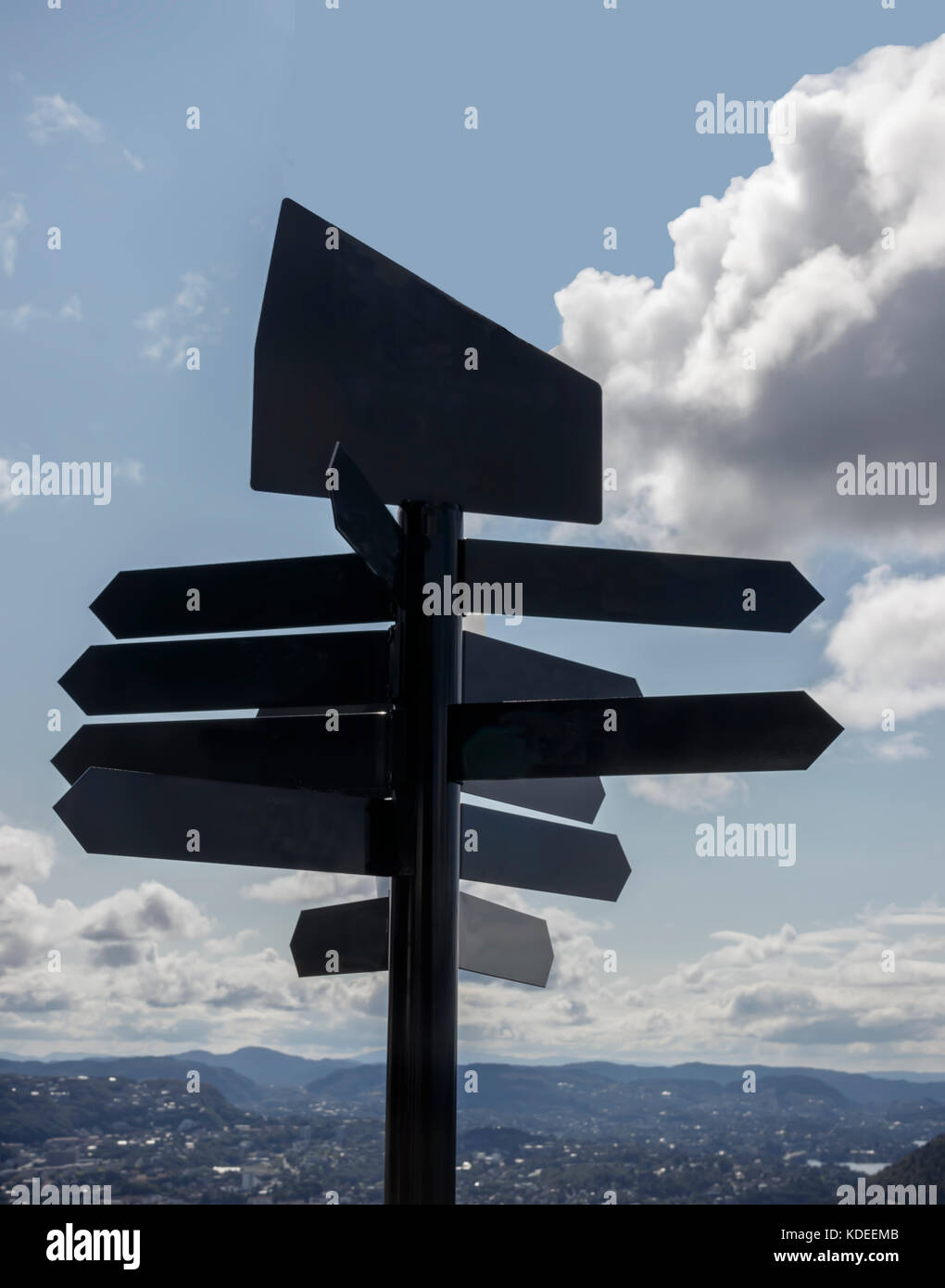 Pillar with black directional arrows on background of cloud sky Stock ...