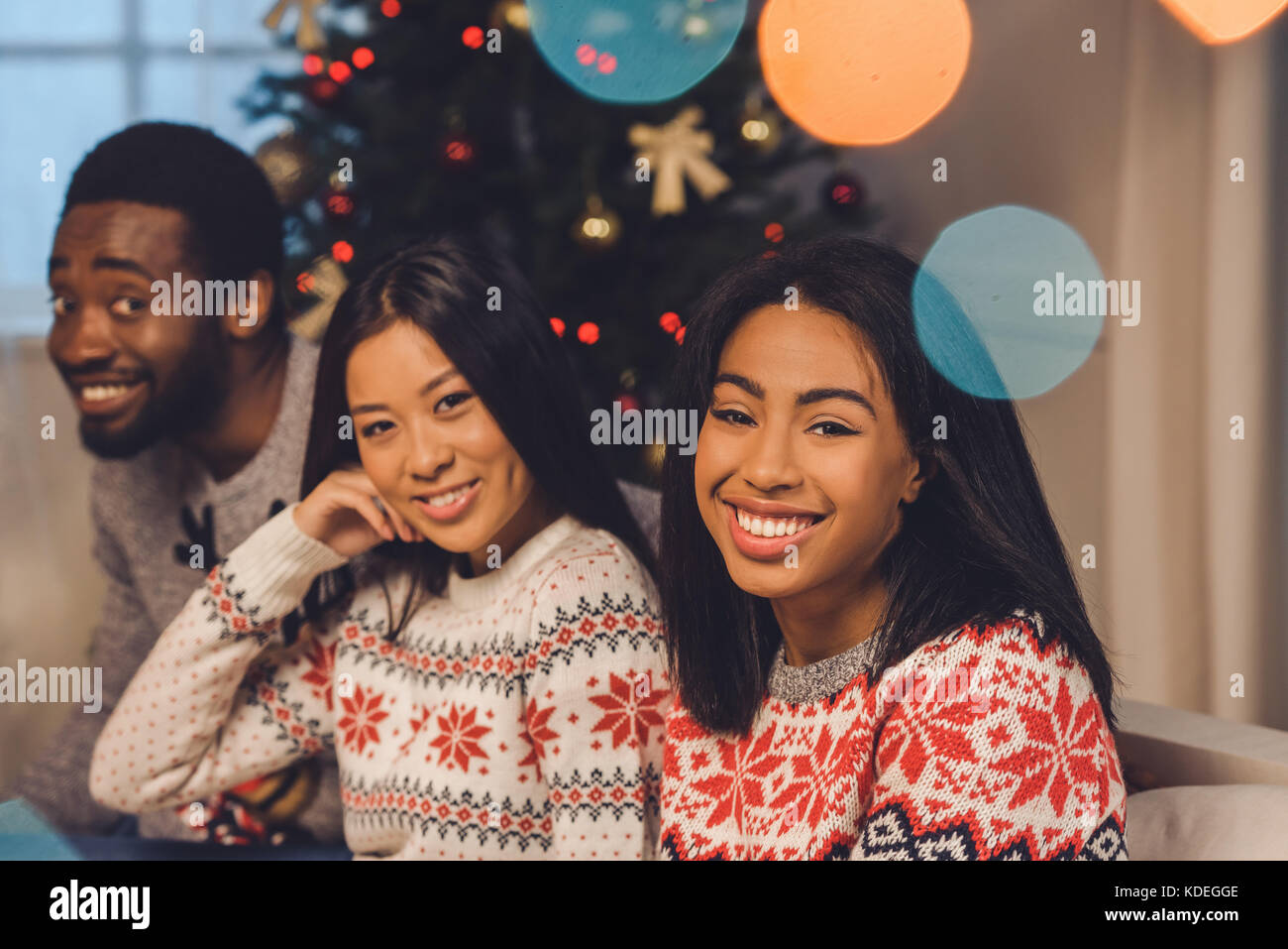 multicultural friends on christmas eve Stock Photo - Alamy