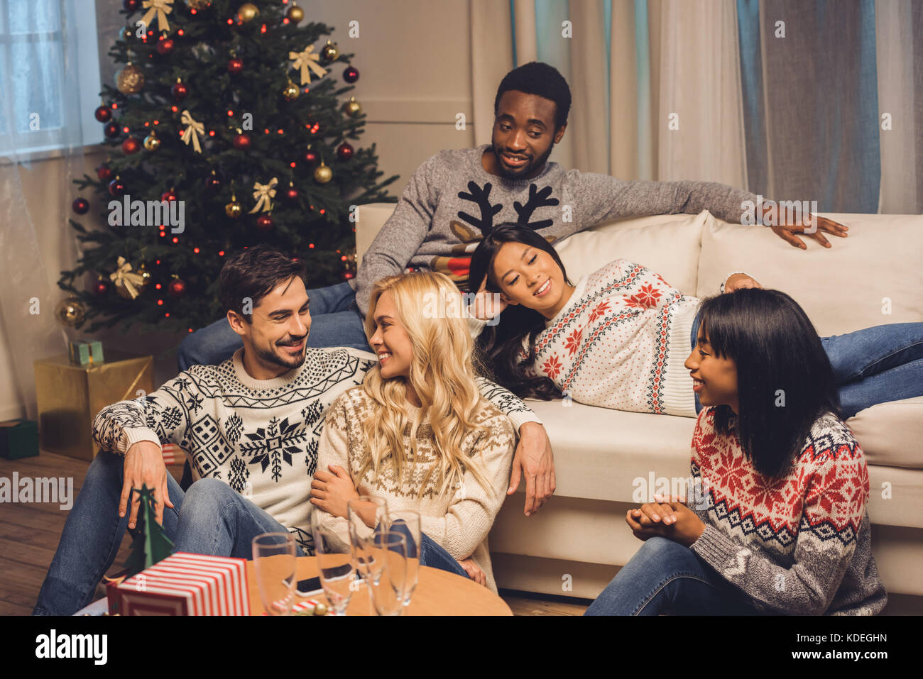 multicultural friends on christmas eve Stock Photo - Alamy