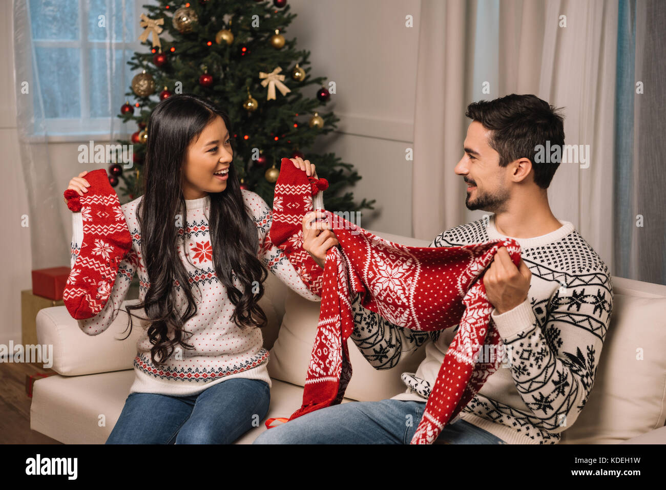 multicultural couple celebrating christmas together Stock Photo - Alamy