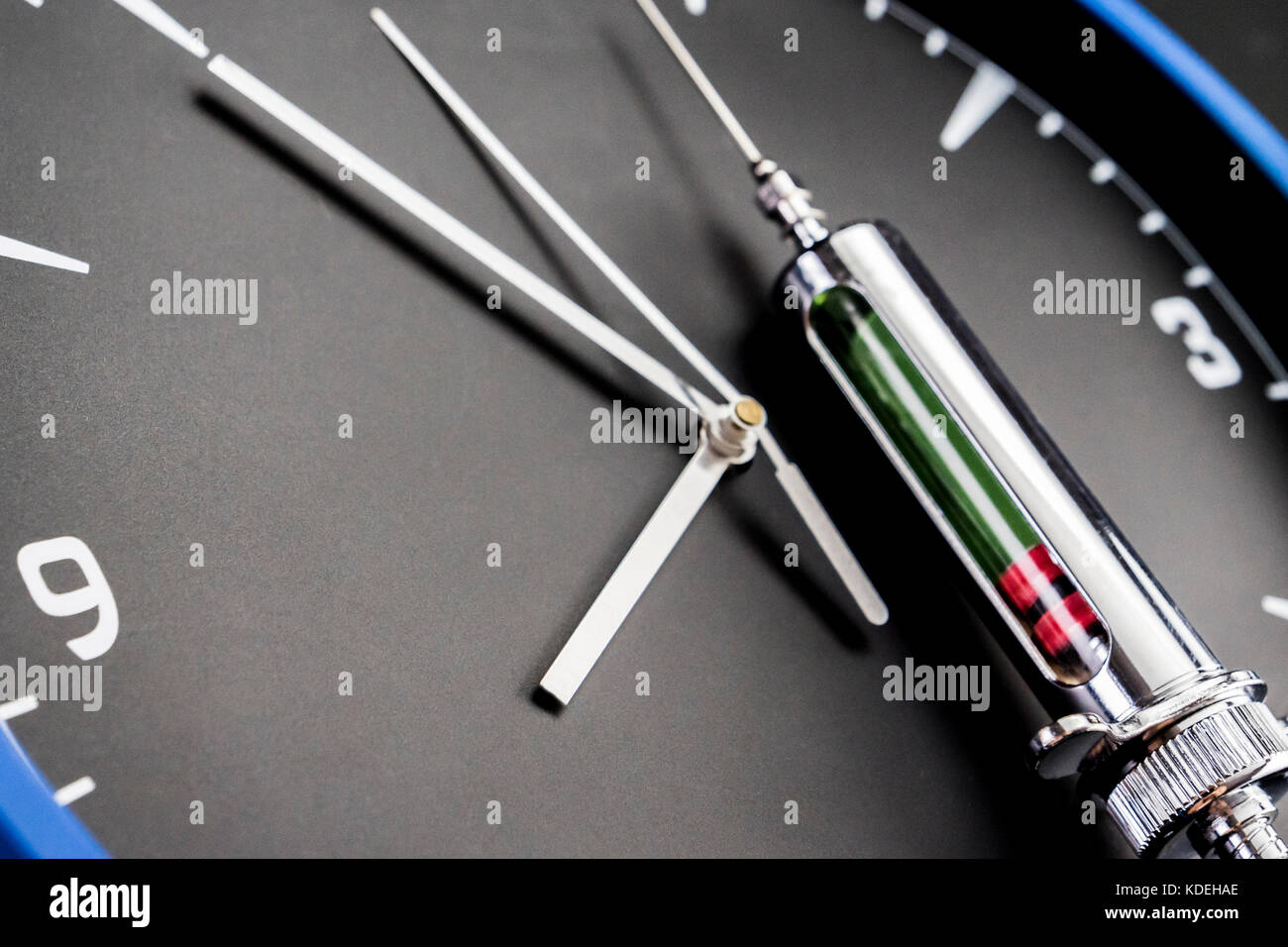 A syringe on a clock in laboratory, conceptual image Stock Photo - Alamy