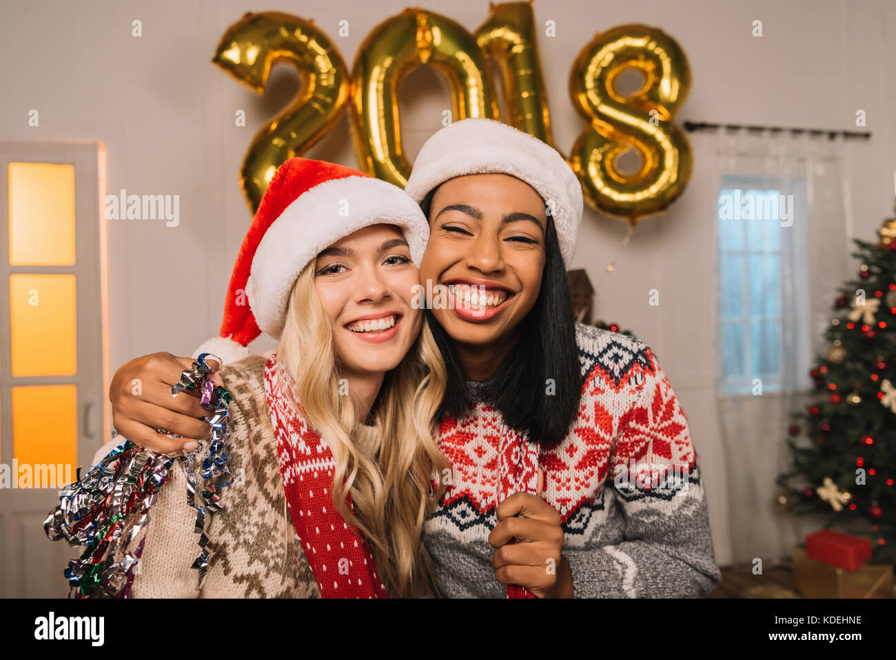 happy multicultural women in santa claus hats Stock Photo - Alamy