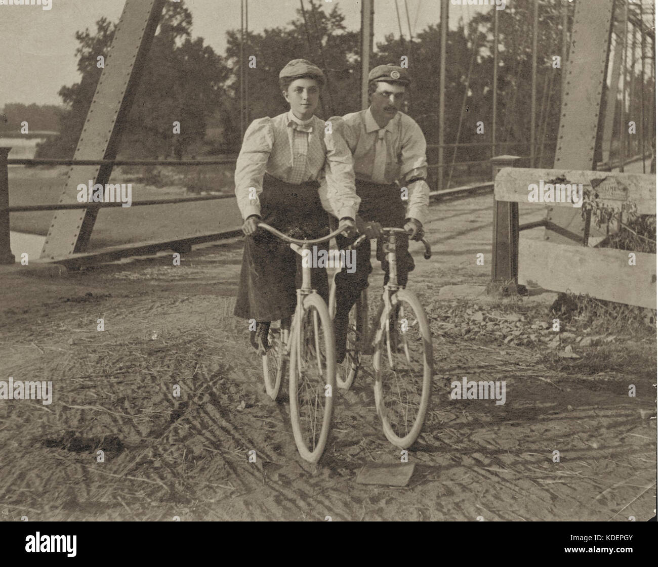 Maud Dunning Hurck and an unidentified male companion crossing a bridge ...