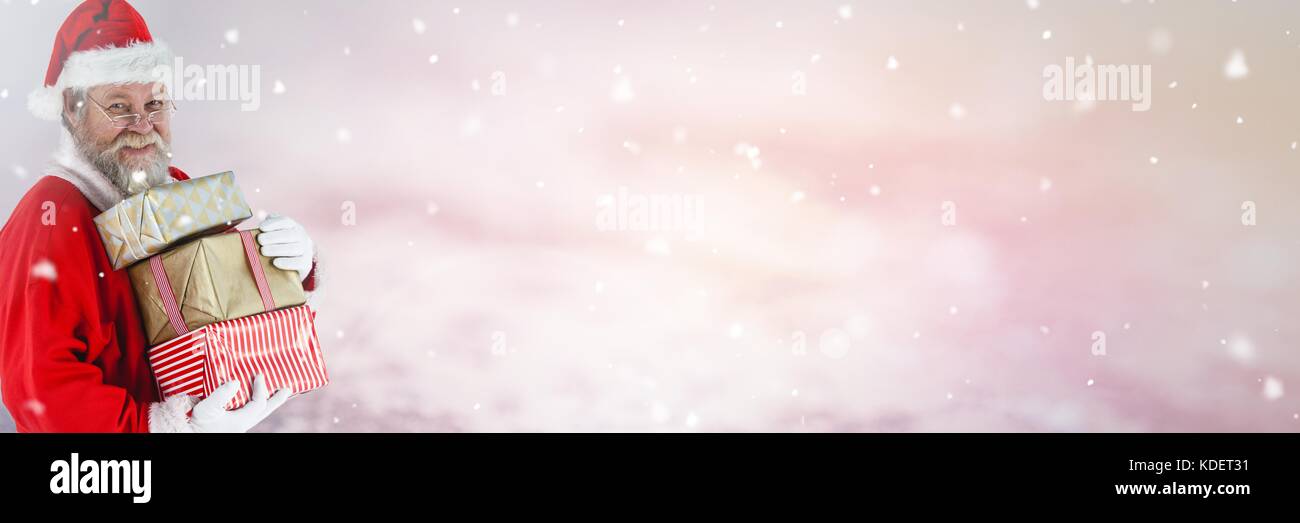 Digital composite of Santa with Winter landscape holding gifts Stock ...
