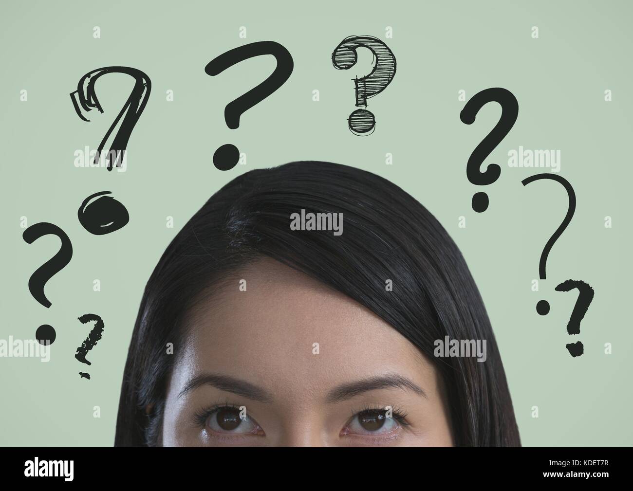 Digital composite of man looking up at questionmarks Stock Photo - Alamy