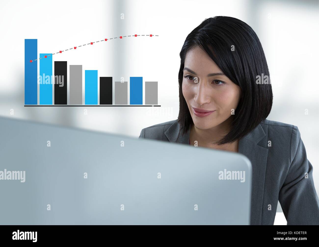 Digital composite of Businesswoman at desk with computer and bar chart ...