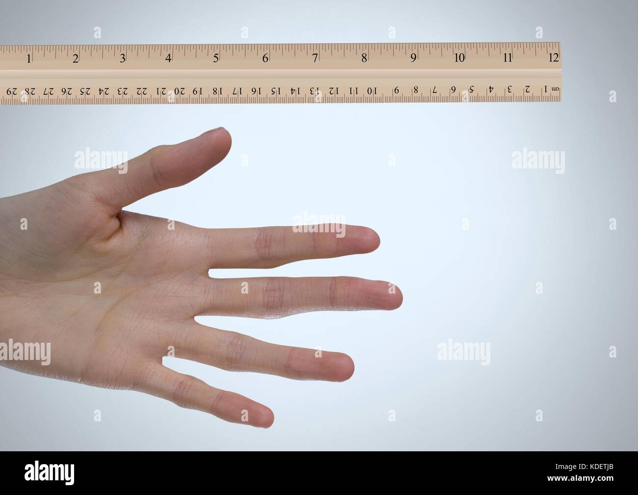 Digital composite of Ruler measuring size of long hand and fingers ...