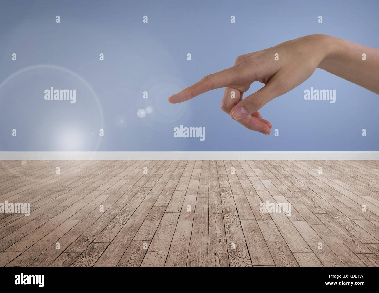 Digital composite of Hand interacting and pointing in blue room Stock ...