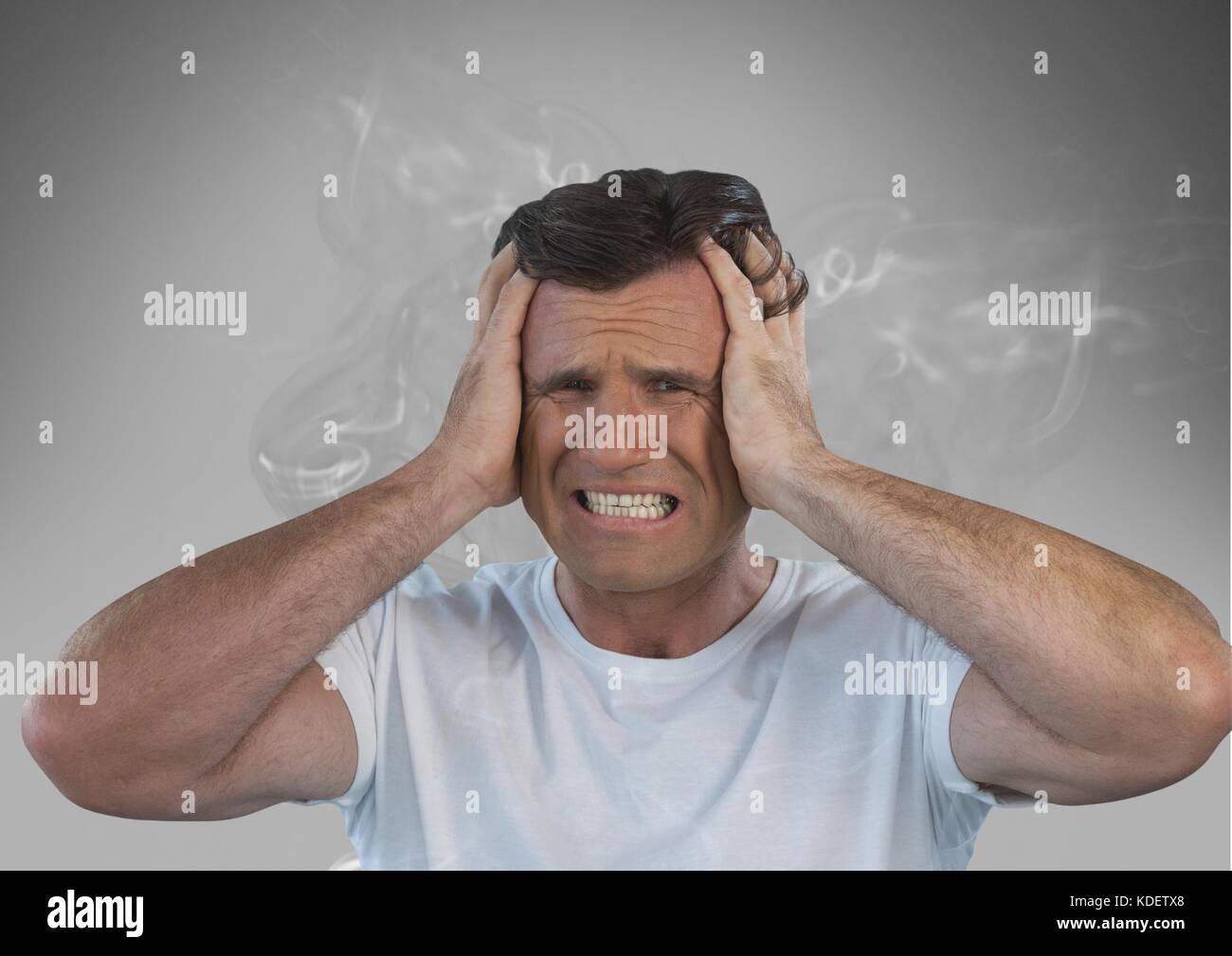 Digital composite of frustrated man with smoke Stock Photo - Alamy