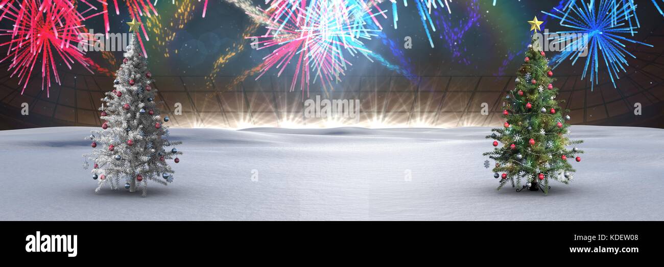 Digital composite of Christmas trees in winter landscape with fireworks ...